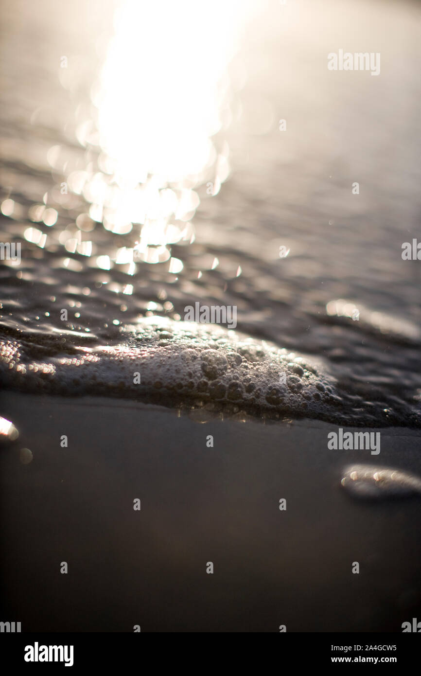 Waves lapping on beach Stock Photo - Alamy
