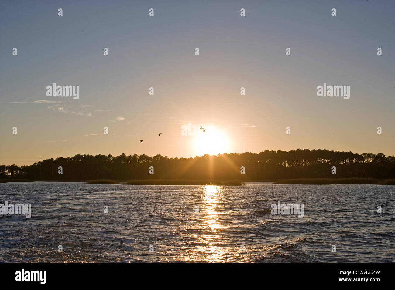 Sunset over water Stock Photo - Alamy