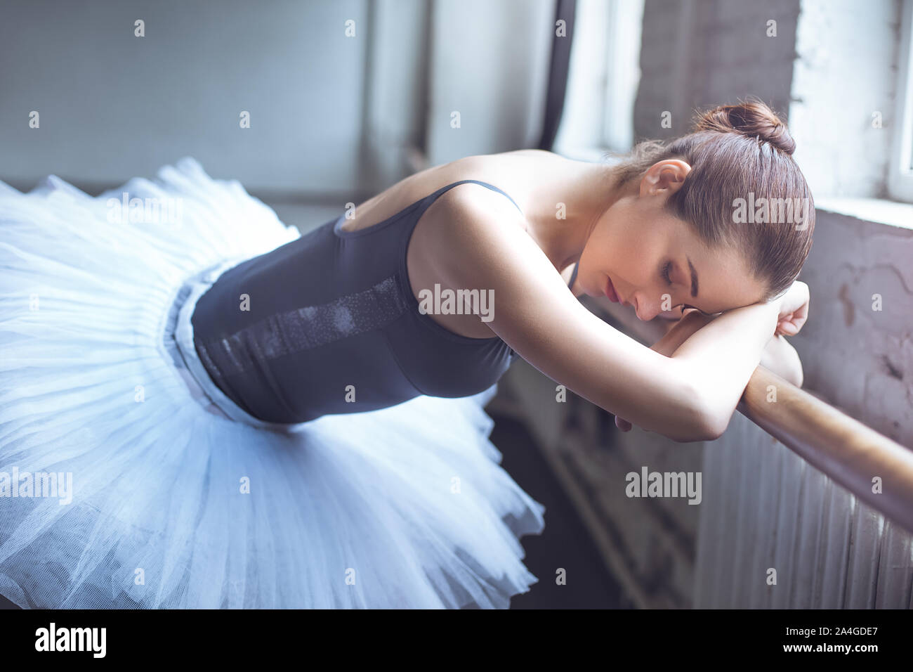 Young ballet dancer lying on crossbar in studio active lifestyle Stock ...