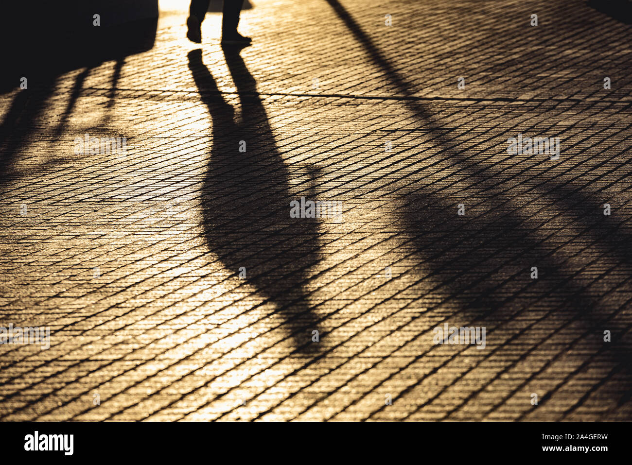 Abstract urban background with diffuse shadow of man walking at sunset ...