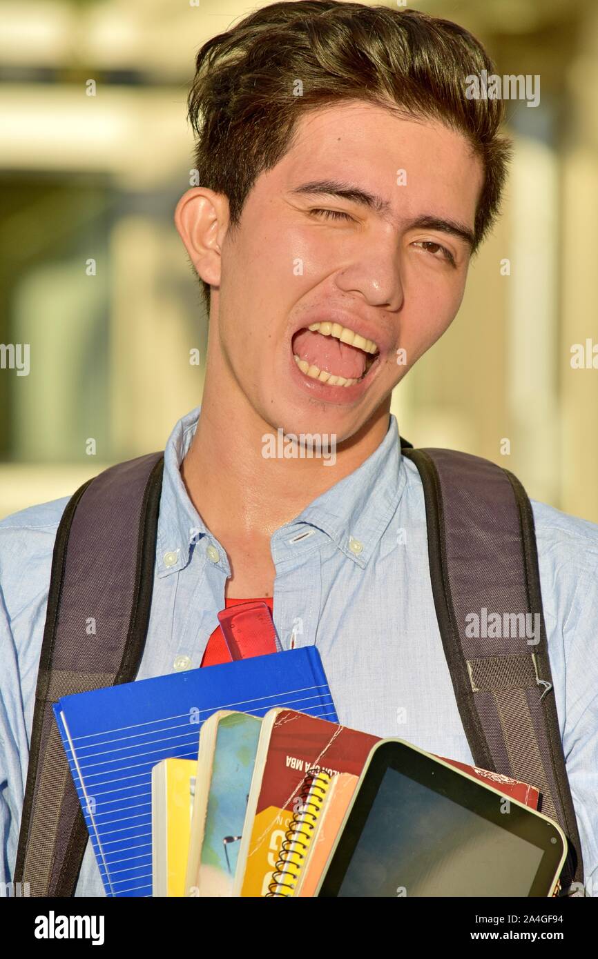 Winking Young Filipino Male Student With Books Stock Photo - Alamy