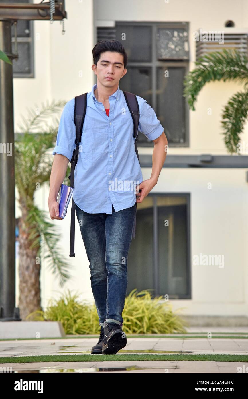 Serious Youthful Asian Person Walking Stock Photo - Alamy