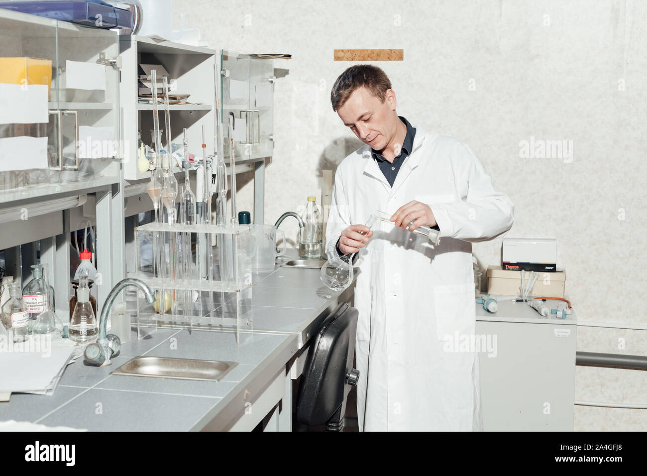 scientist conducts chemical experiments with liquids in the medical ...