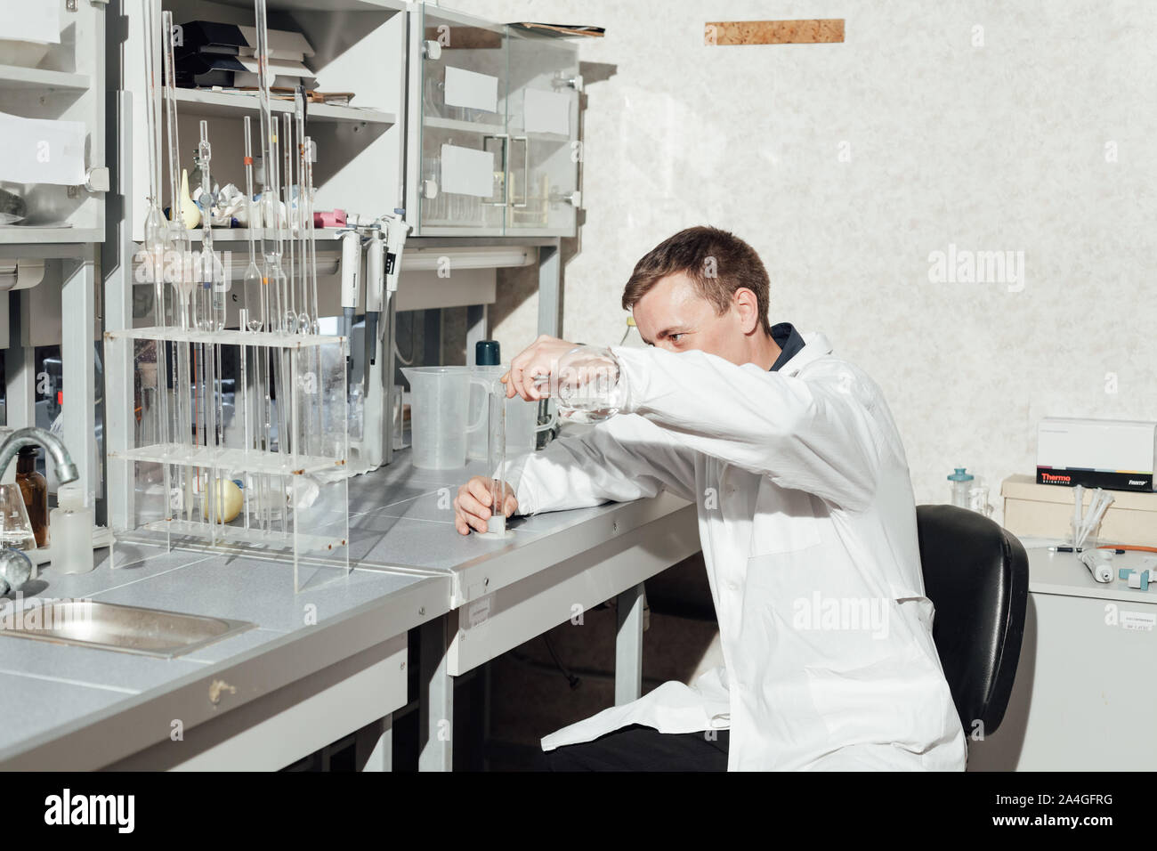 scientist conducts chemical experiments with liquids in the medical ...