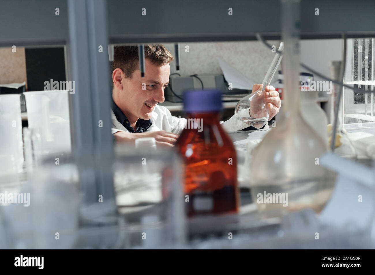 scientist conducts chemical experiments with liquids in the medical ...