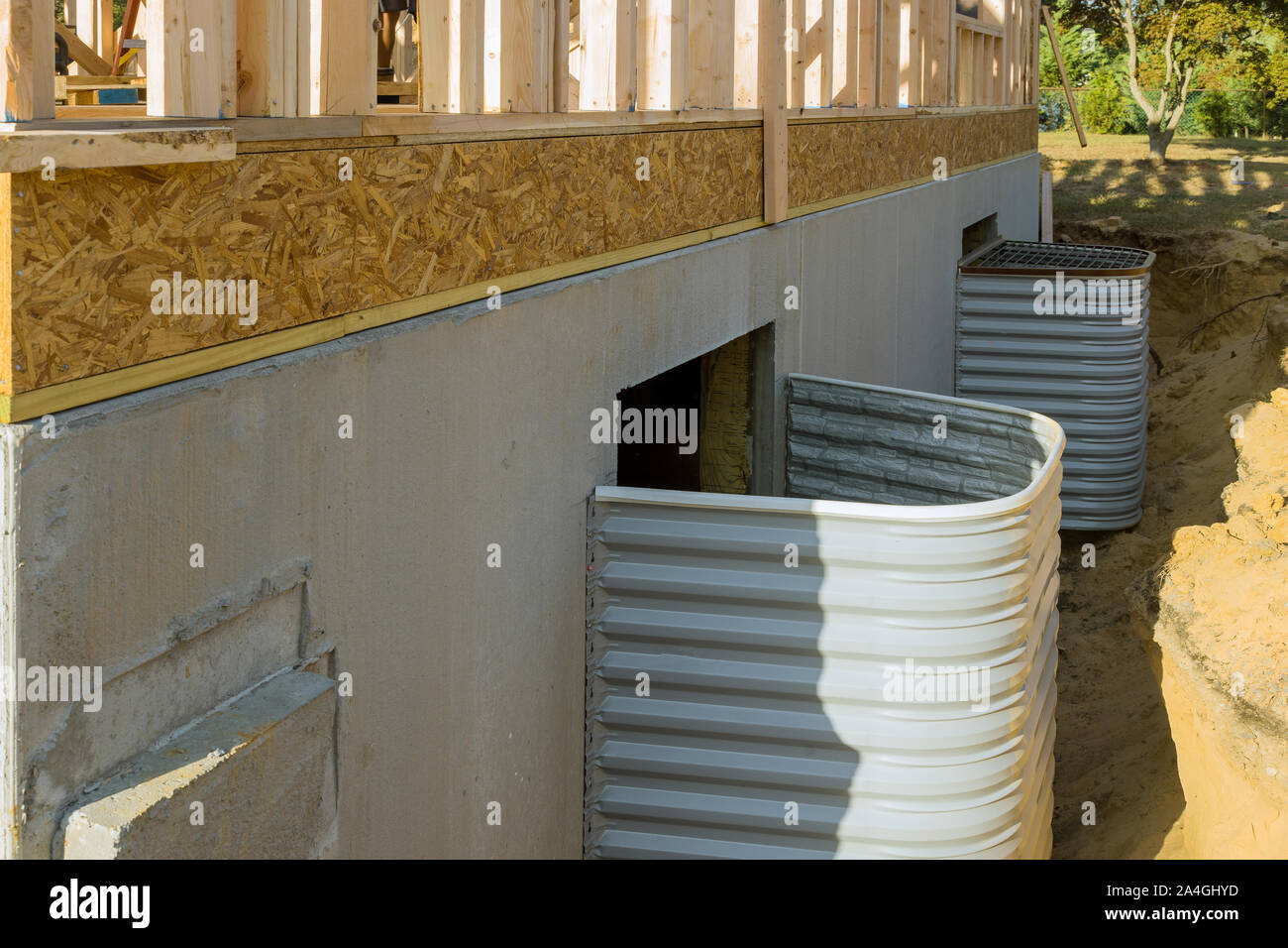 New house under construction process of installing window well basement ...