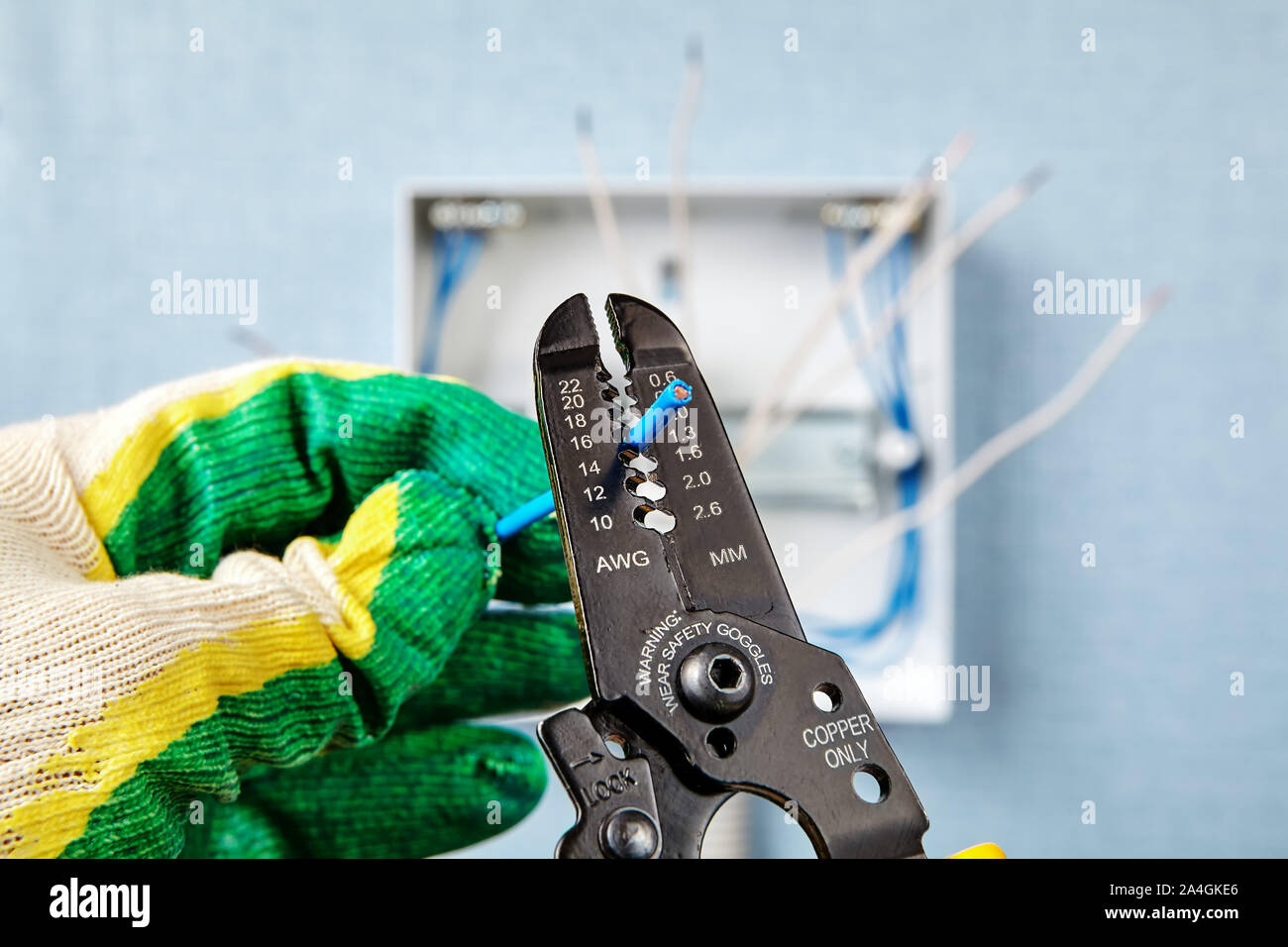 Service of household wiring. The technician removes the insulation from ...