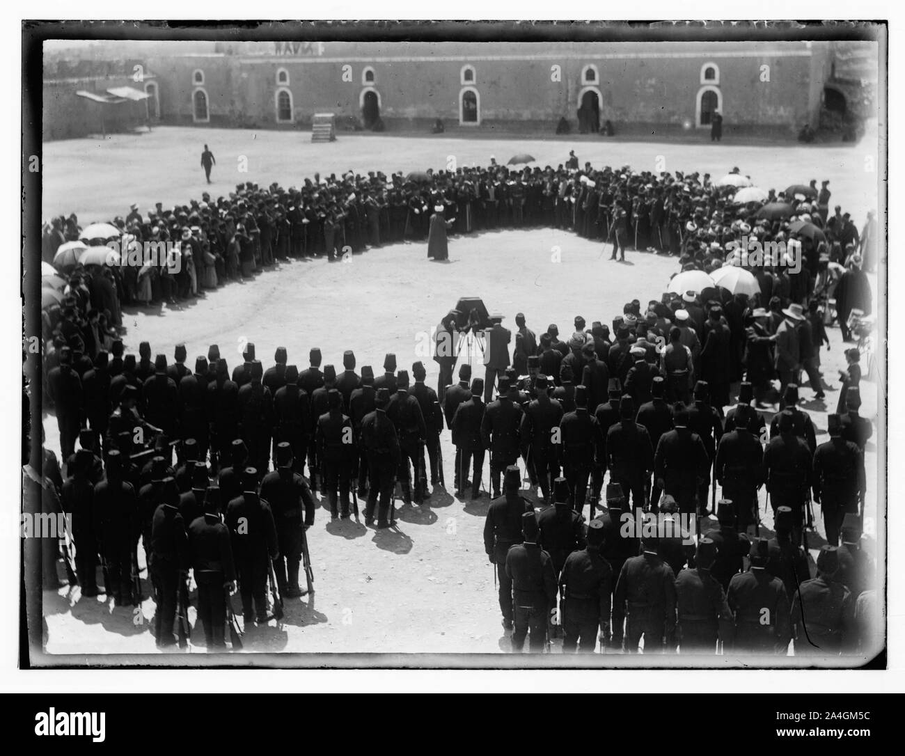 Turkish military WWI. Man being photographed in a circle of people with ...