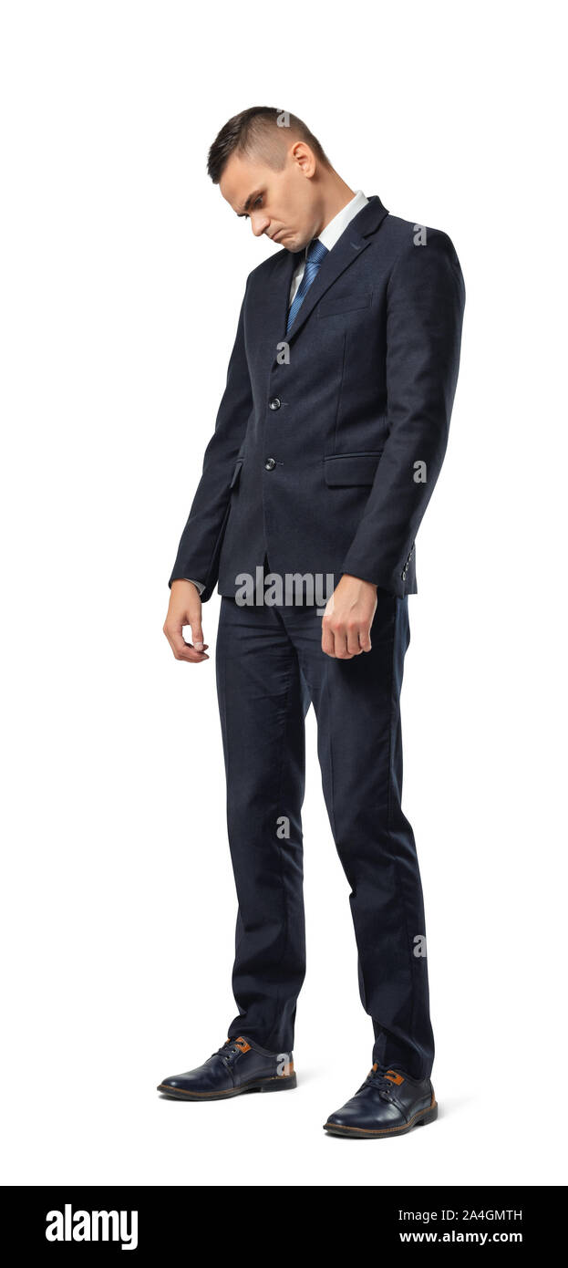 Full growth portrait of businessman standing with bowed head and ...