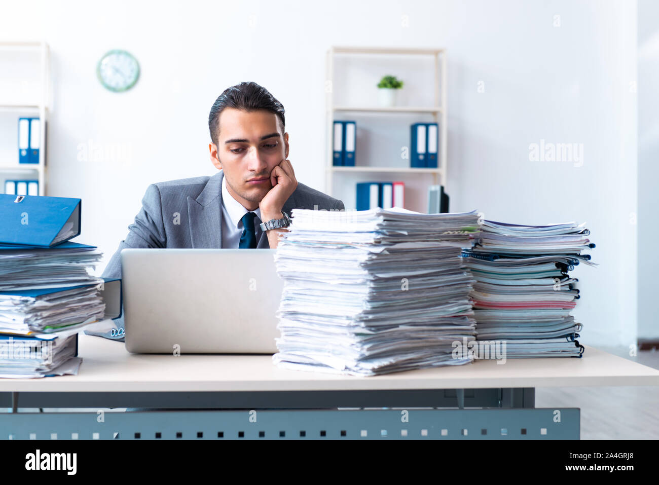 The businessman with heavy paperwork workload Stock Photo - Alamy