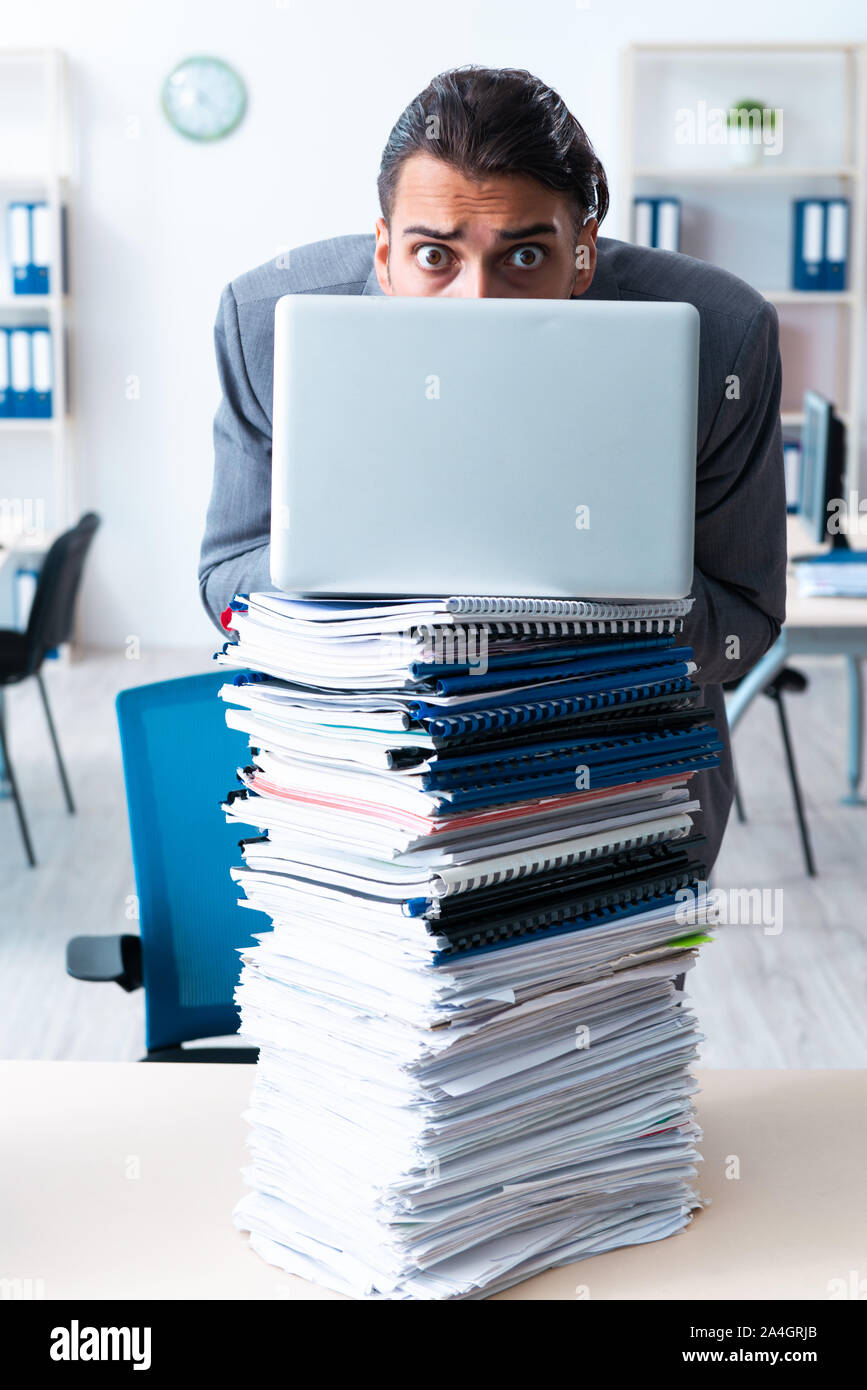 The businessman with heavy paperwork workload Stock Photo - Alamy