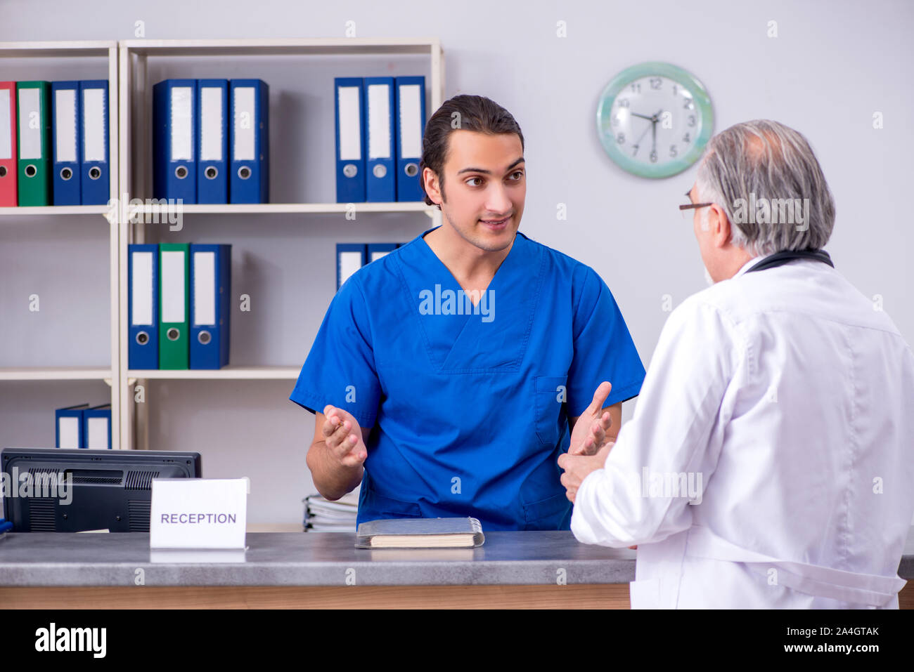 Doctors talking at the reception in hospital Stock Photo - Alamy