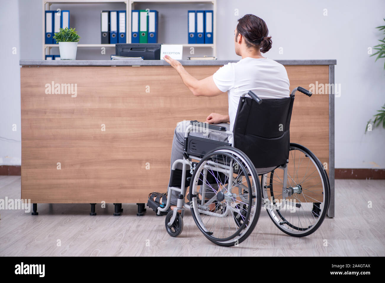 Clinic reception counter and young patient Stock Photo - Alamy
