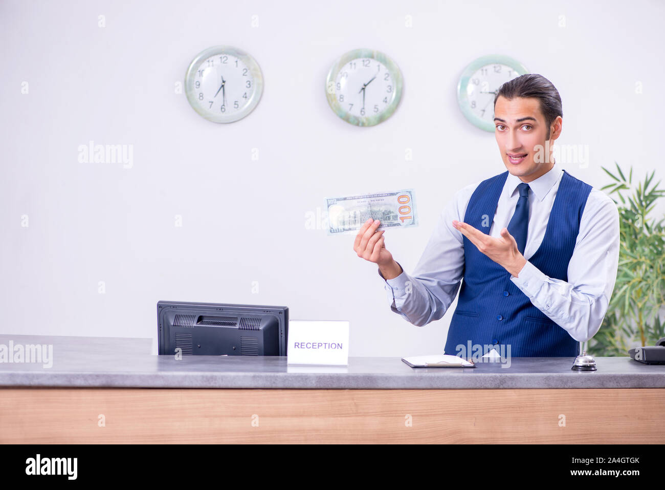 The young man receptionist at the hotel counter Stock Photo - Alamy