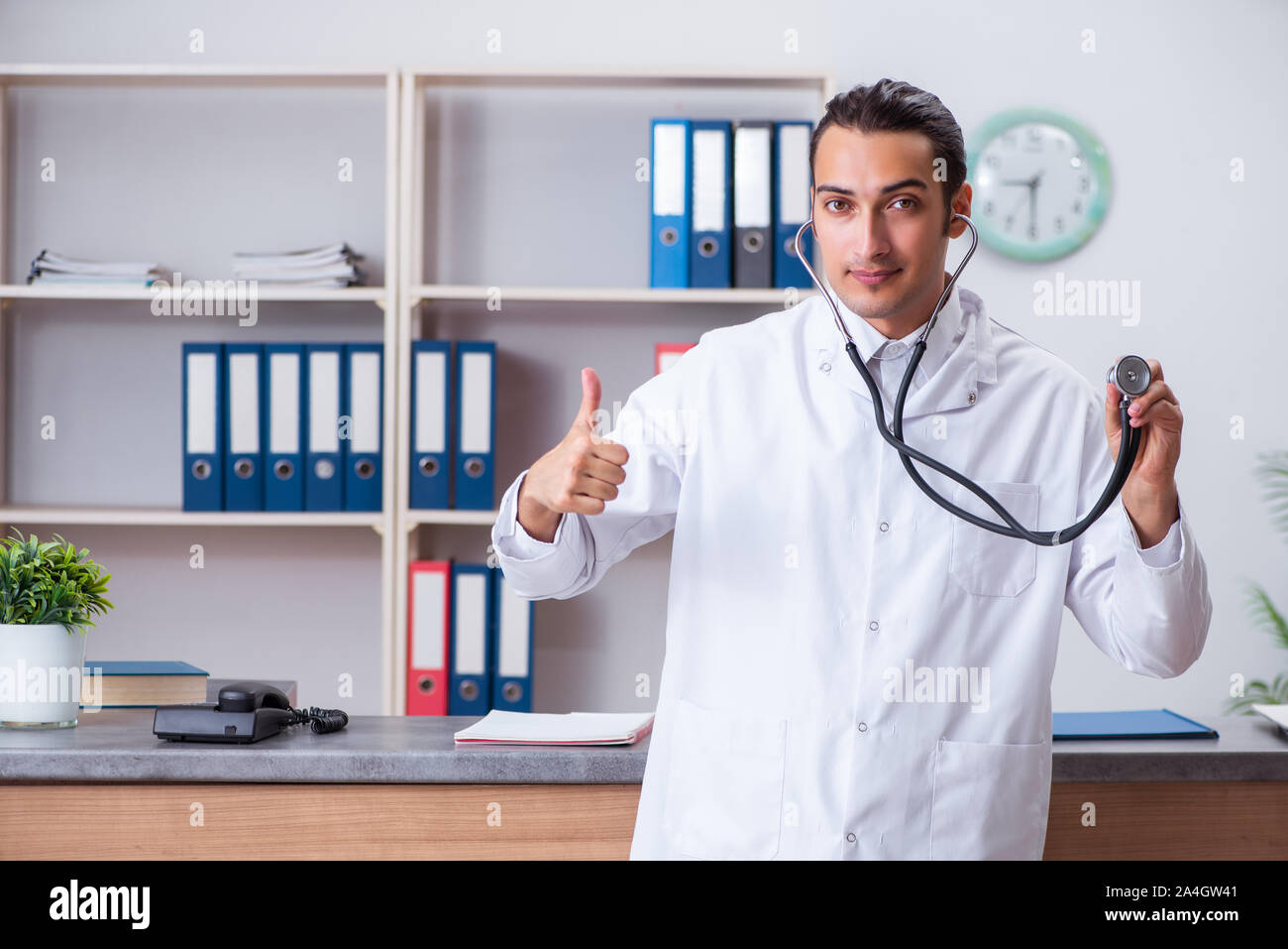 The young male doctor at the reception in the hospital Stock Photo - Alamy