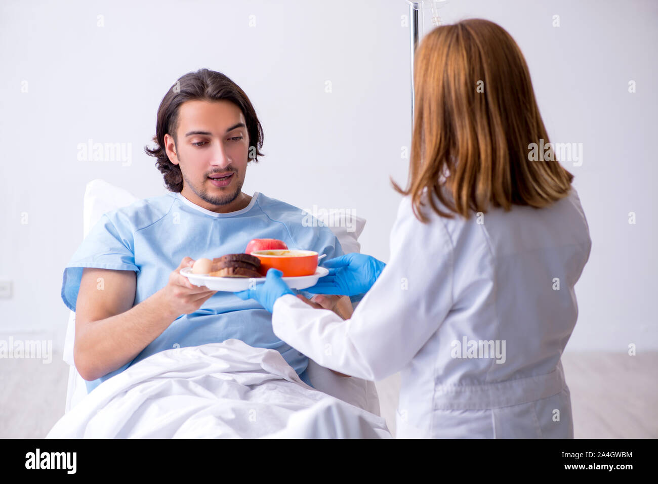 The male patient eating food in the hospital Stock Photo - Alamy