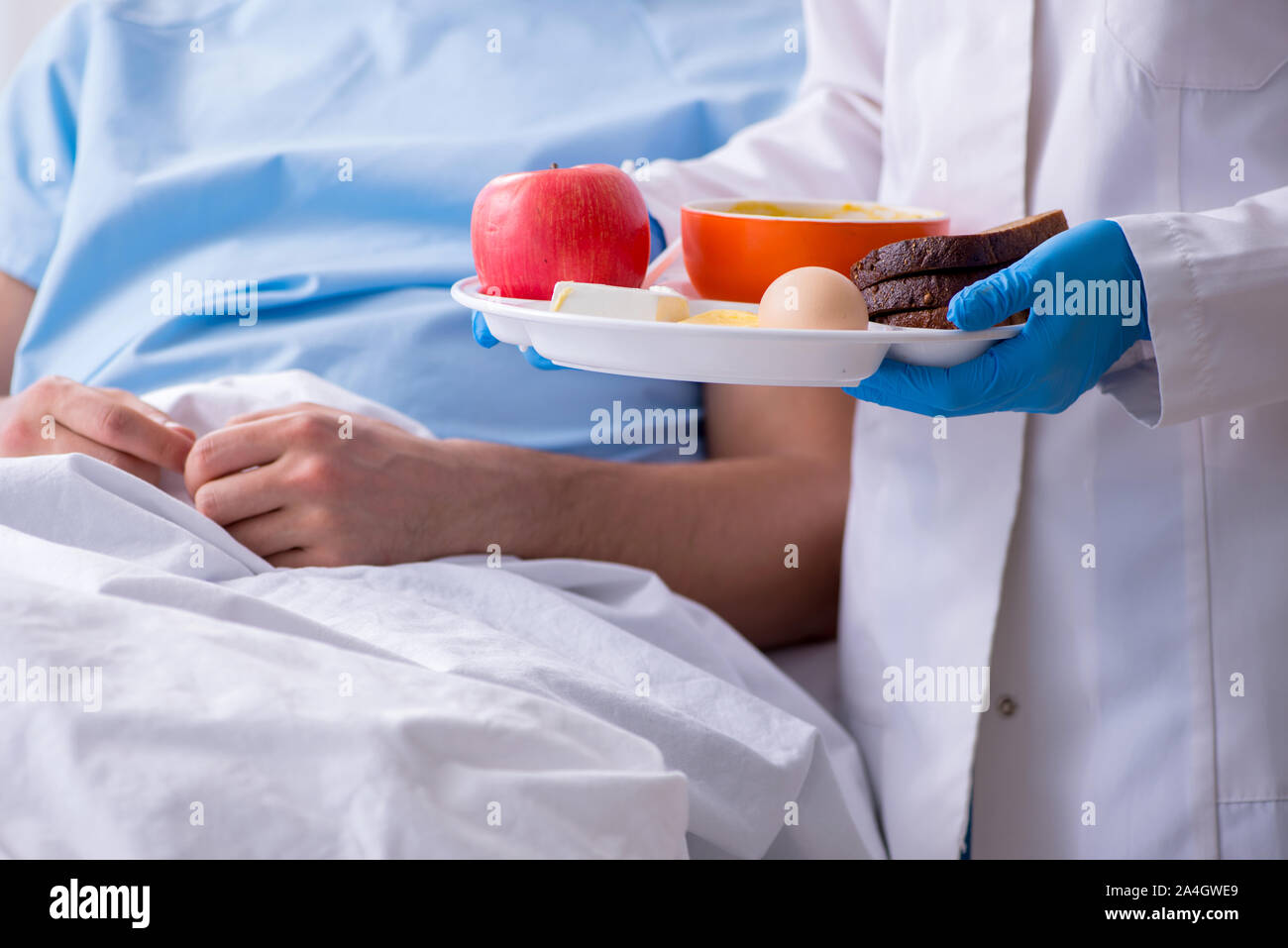 The male patient eating food in the hospital Stock Photo - Alamy