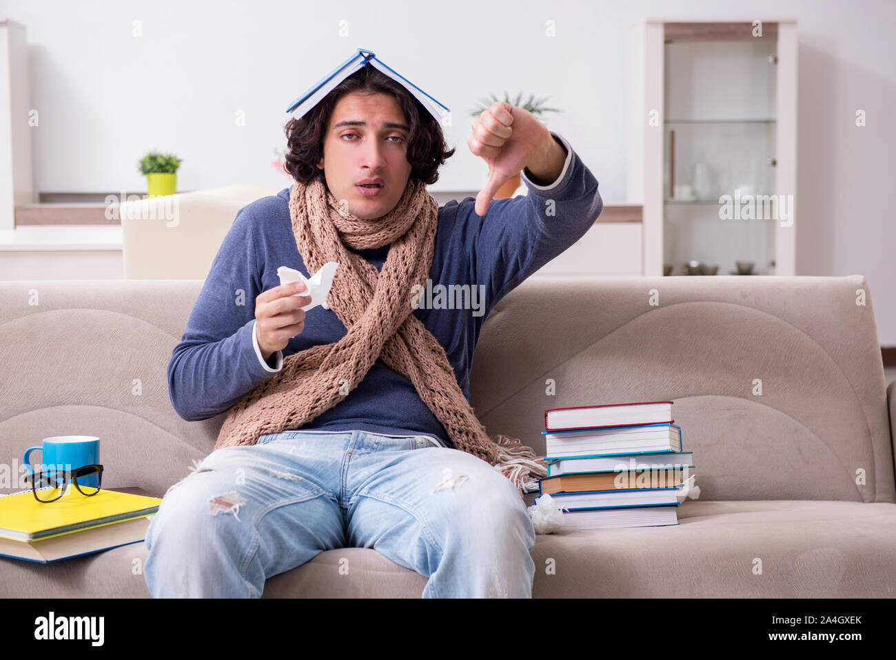 The sick male student suffering at home Stock Photo - Alamy