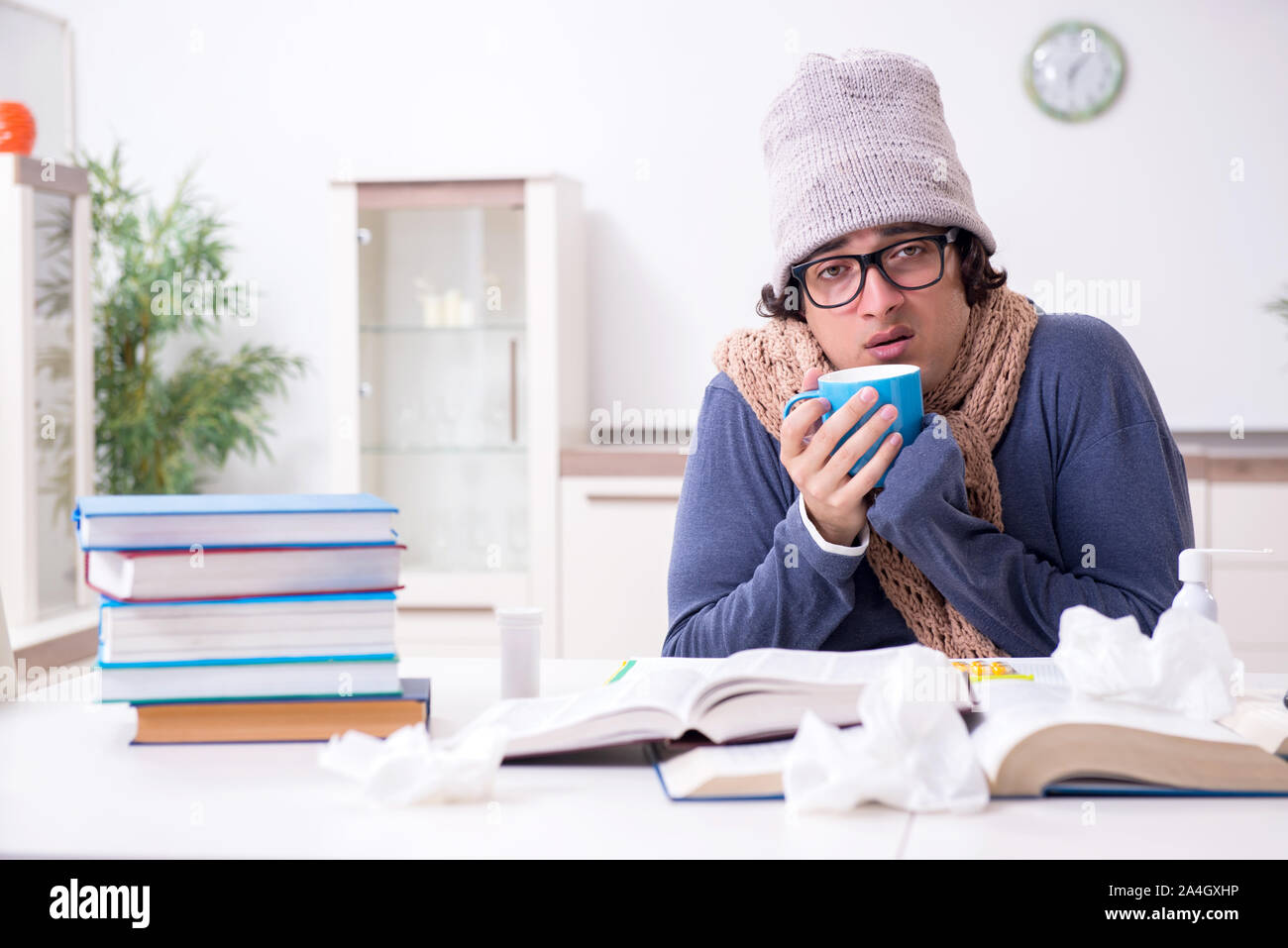 The sick male student suffering at home Stock Photo - Alamy