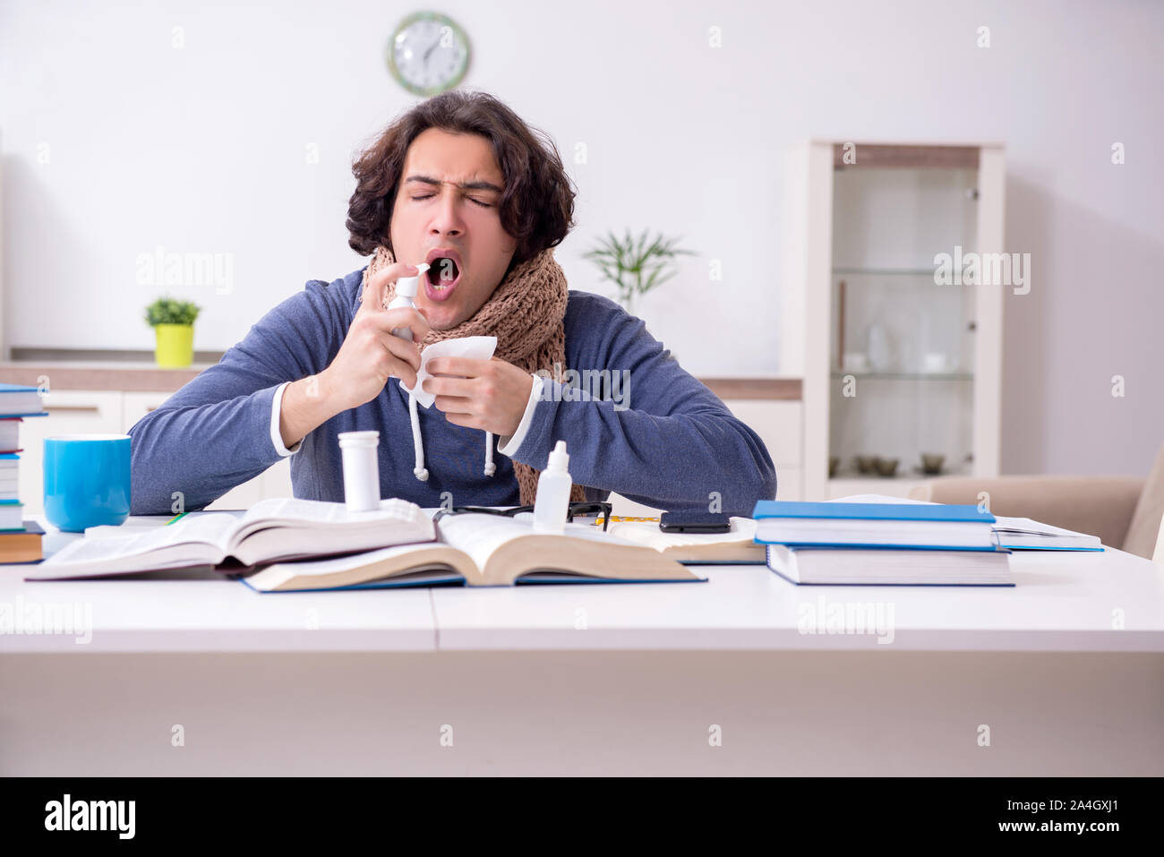 The sick male student suffering at home Stock Photo - Alamy