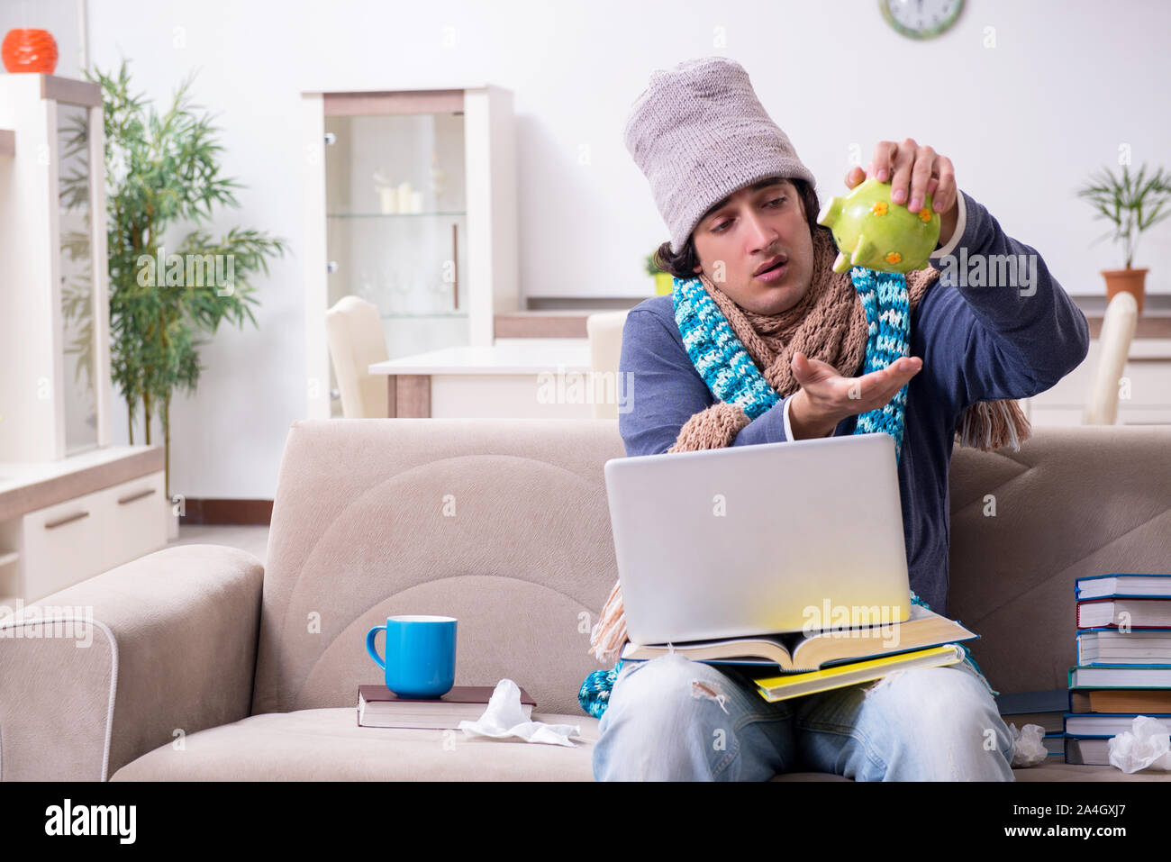 The sick male student suffering at home Stock Photo - Alamy