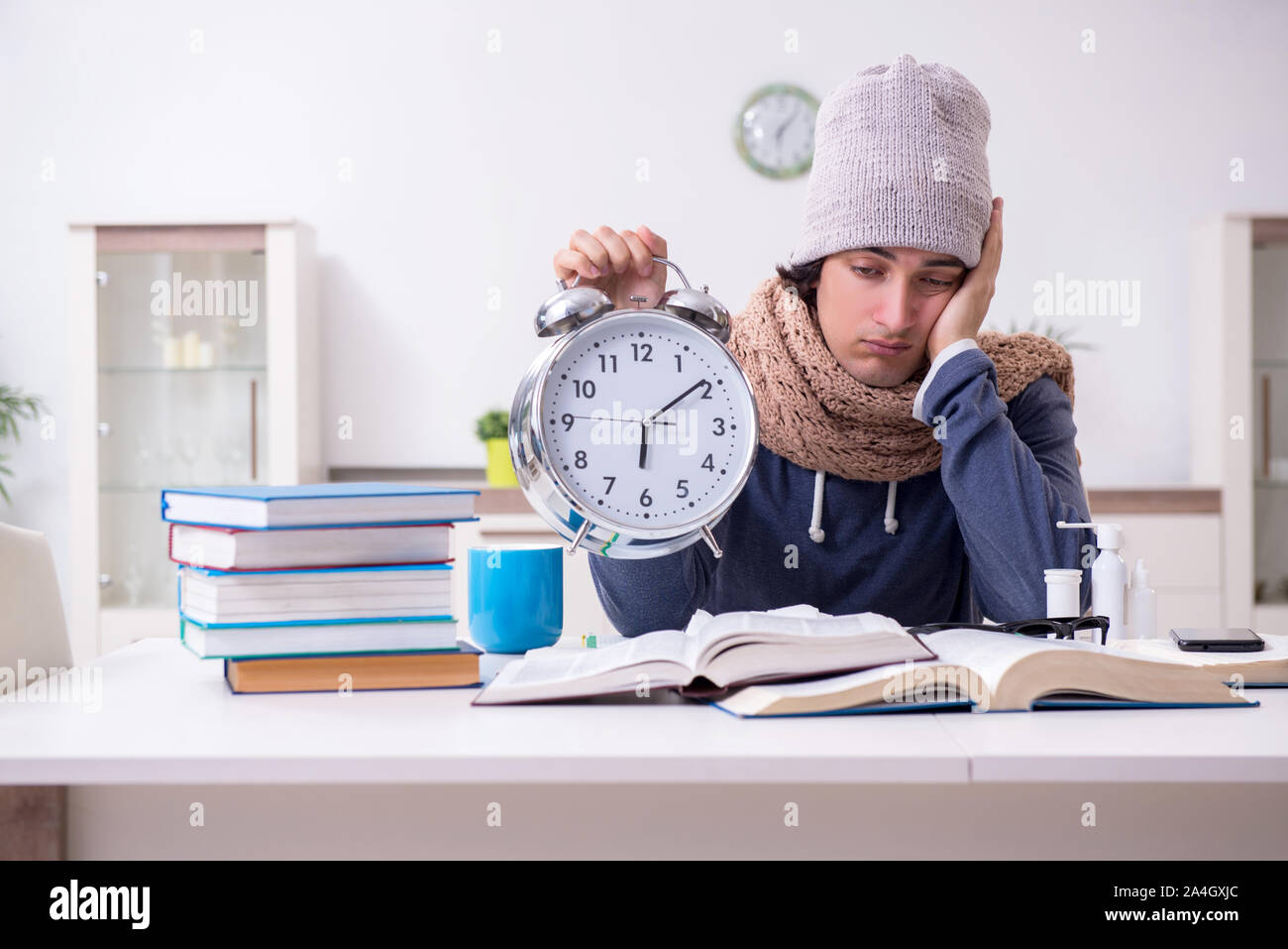 The sick male student suffering at home Stock Photo - Alamy