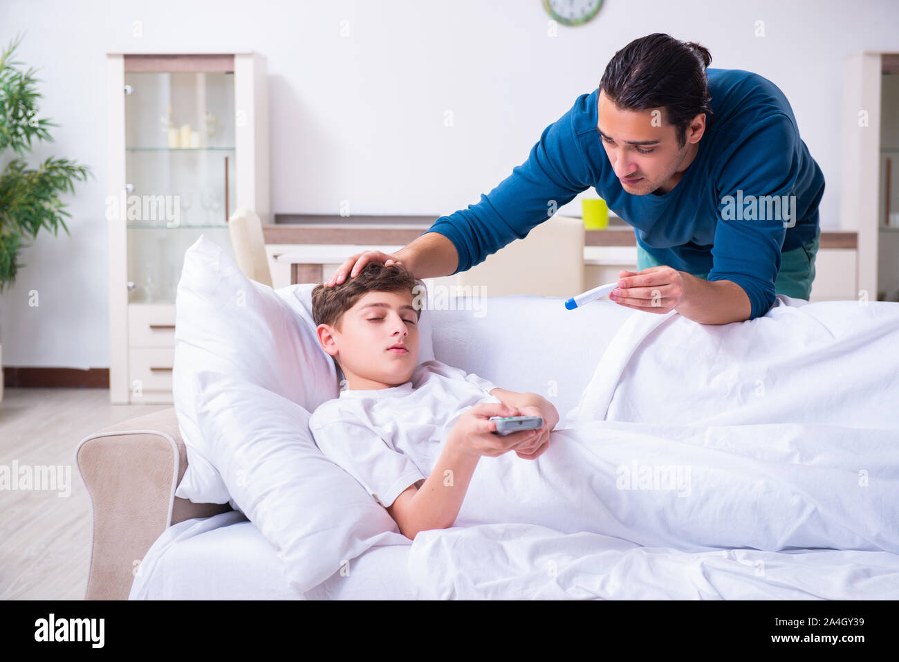 The young father caring for sick son Stock Photo - Alamy