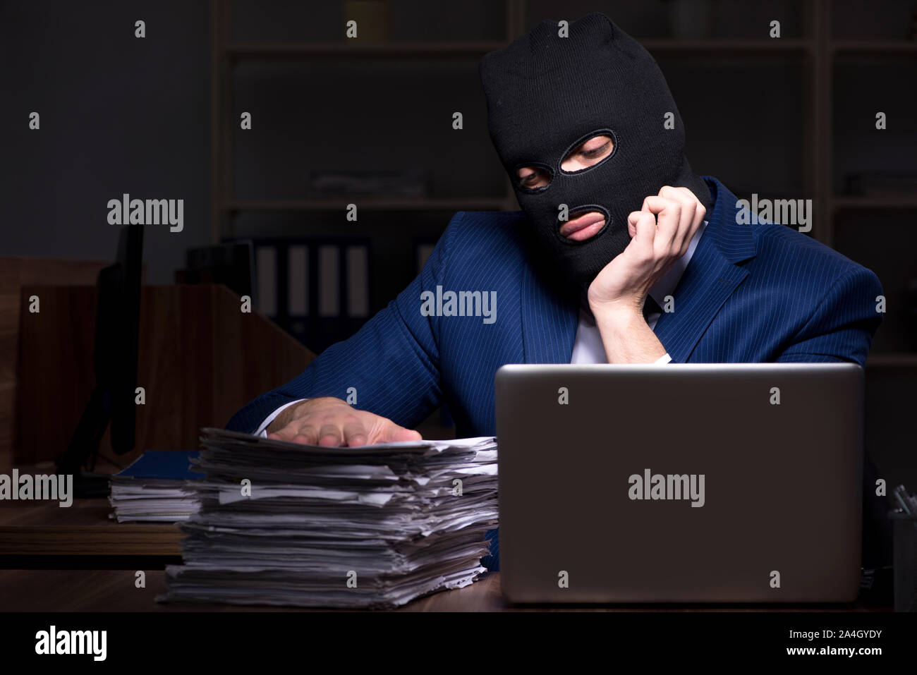 The male employee stealing information in the office night time Stock ...