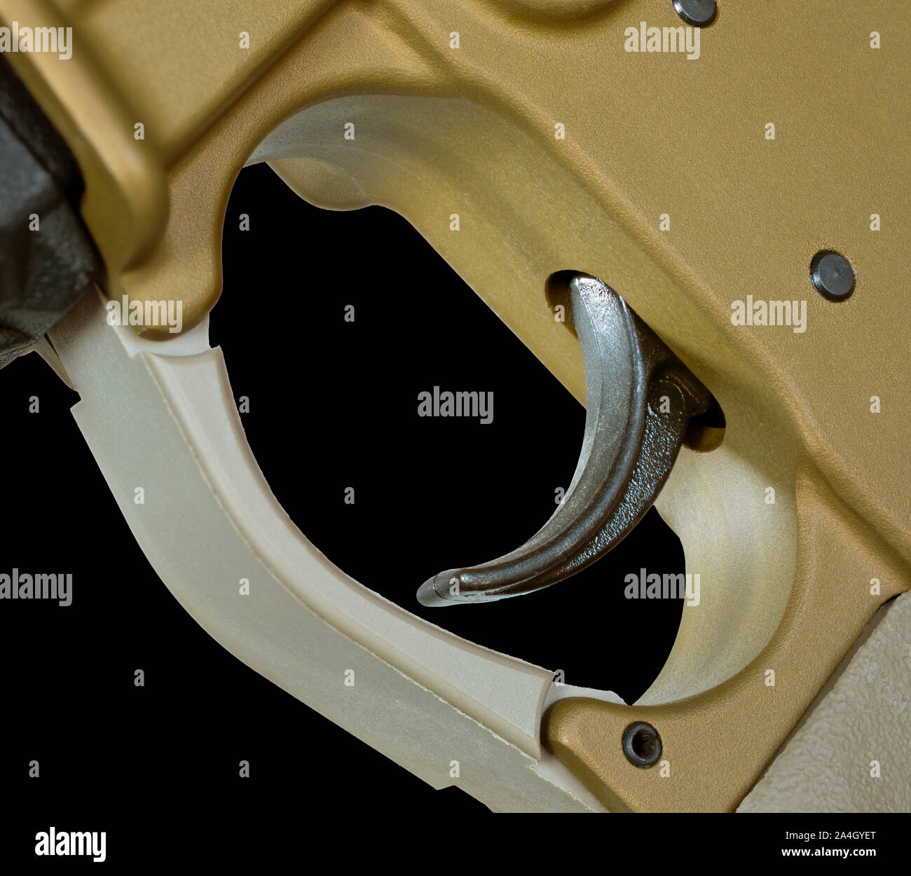 Trigger that is on a copper colored AR-15 with a black background Stock ...