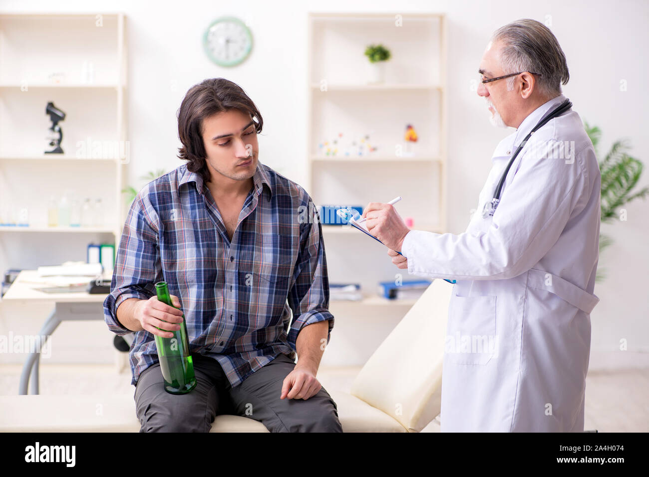 The young male alcoholic visiting old doctor Stock Photo - Alamy