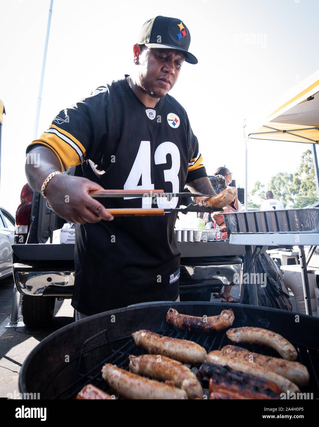 A Steeler fan barbecues at a tailgate party before an NFL football game ...