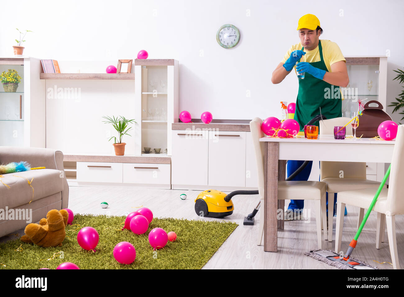 Young male contractor doing housework after party hi-res stock ...