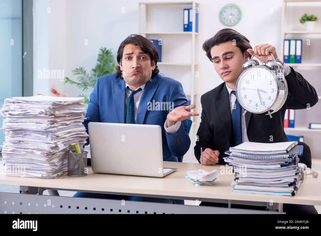 The two male colleagues unhappy with excessive work Stock Photo - Alamy