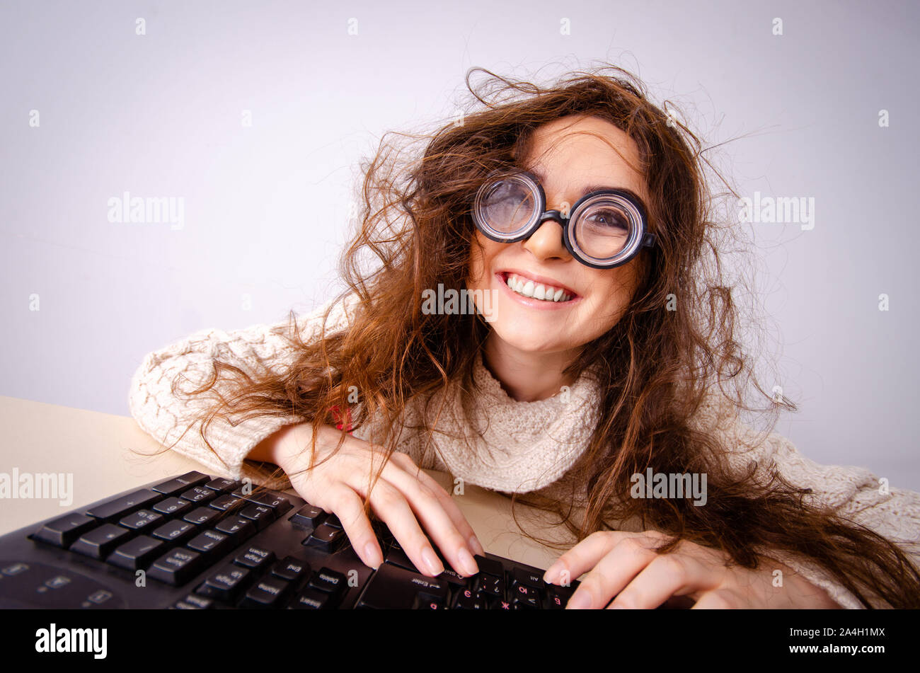 The funny nerd girl working on computer Stock Photo - Alamy