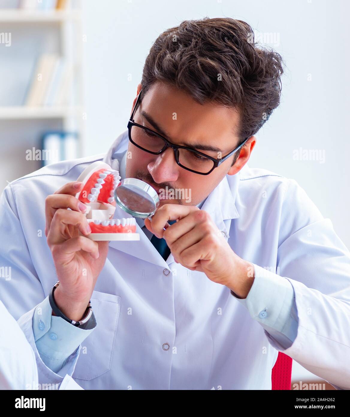 The dentist doctor and assistant working on new tooth implant Stock ...