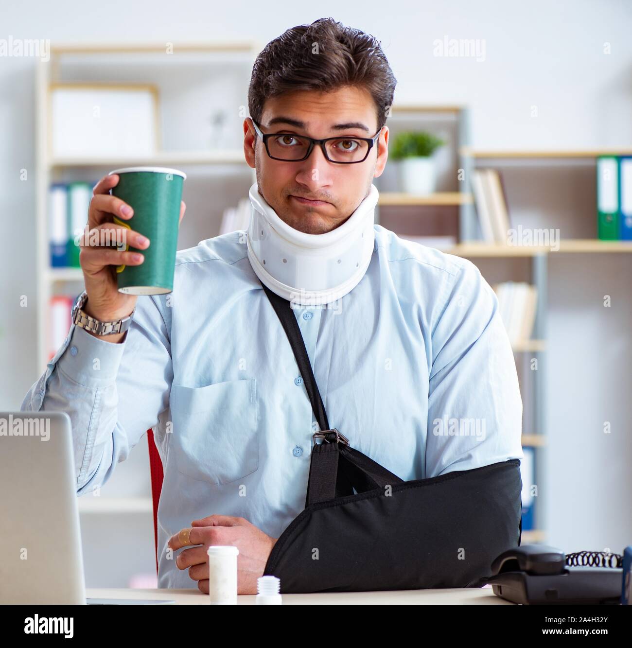 The businessman with broken arm working in office Stock Photo - Alamy