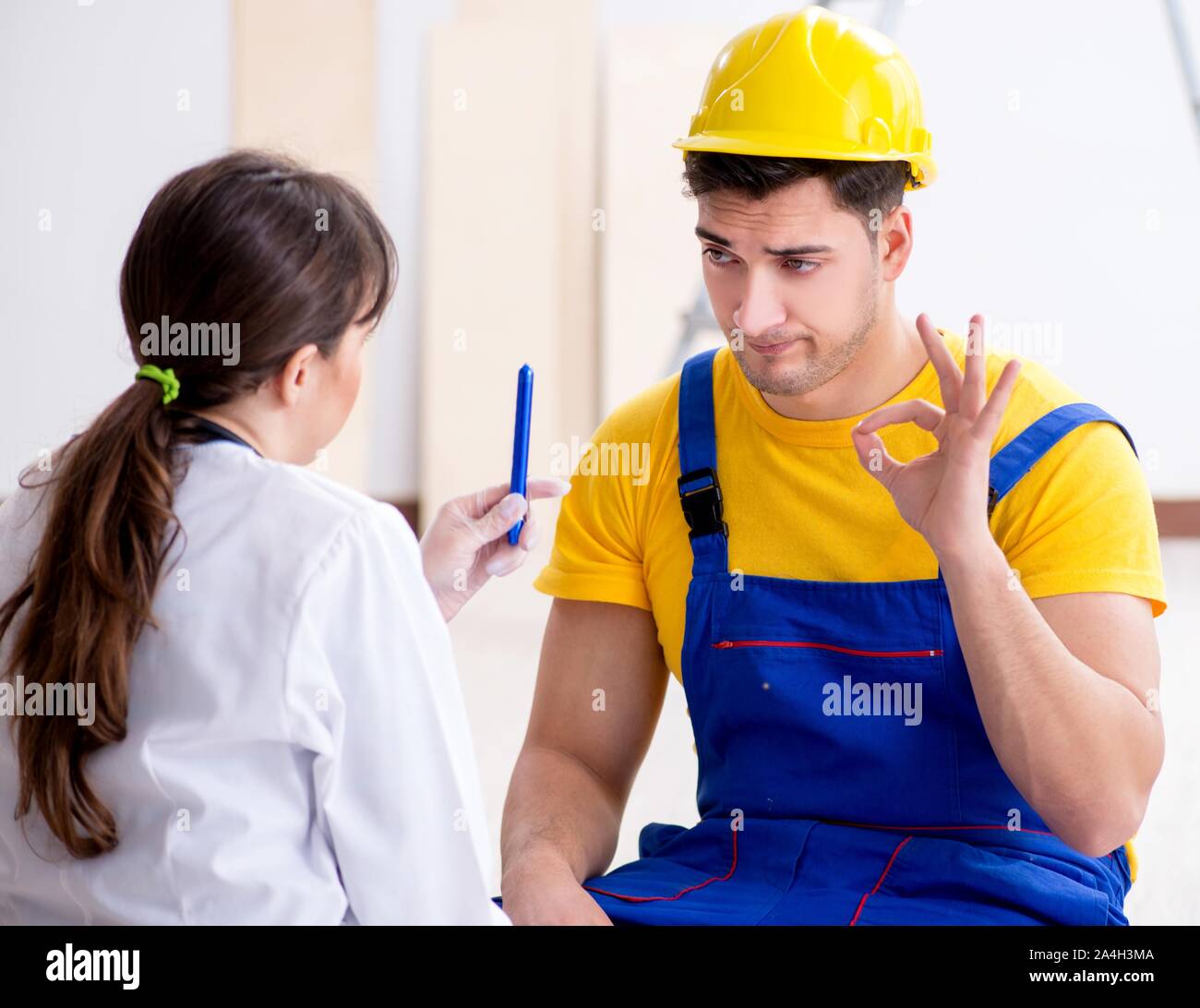 The doctor helping injured worker at construction site Stock Photo - Alamy