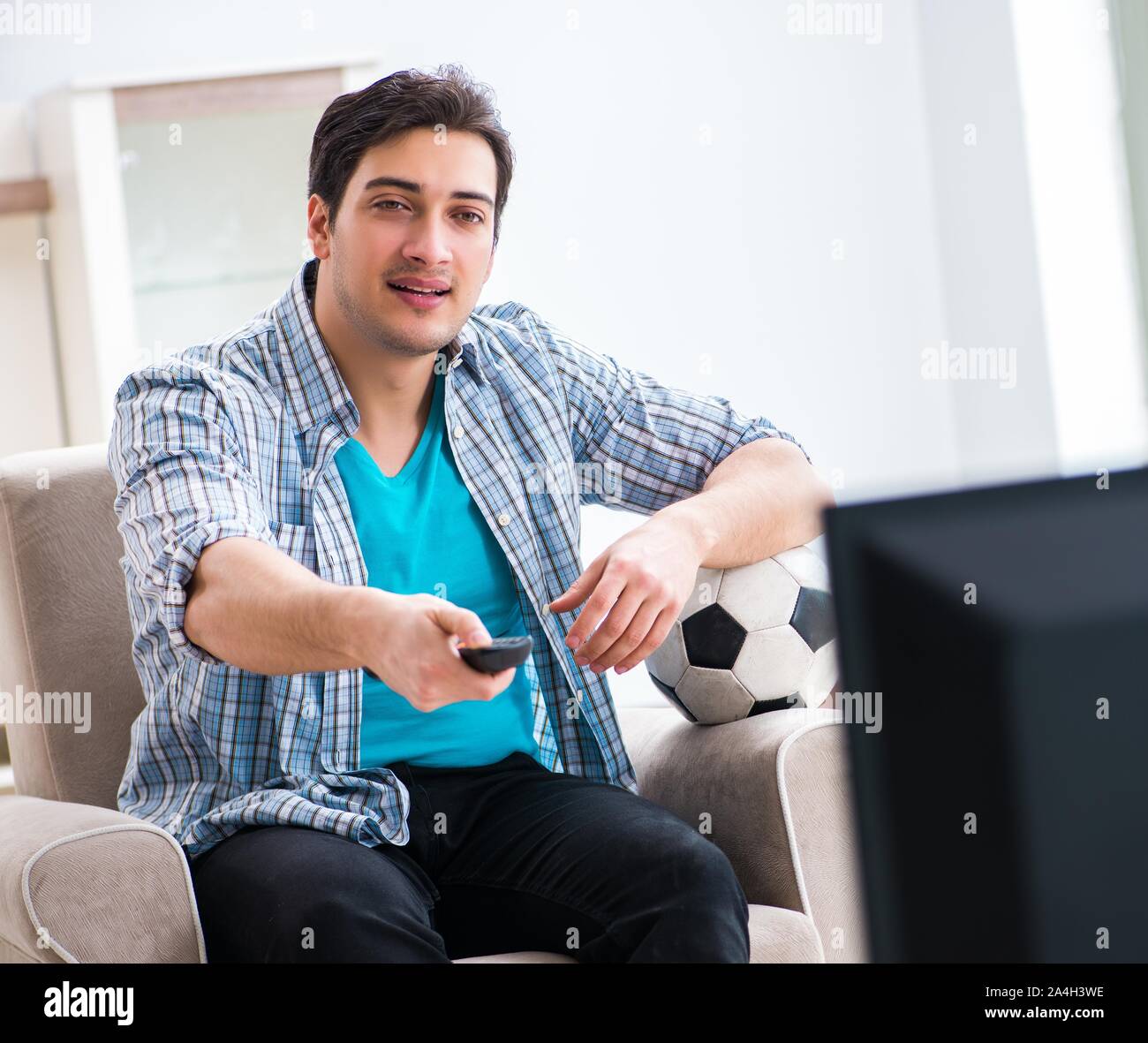 The man watching tv at home Stock Photo - Alamy