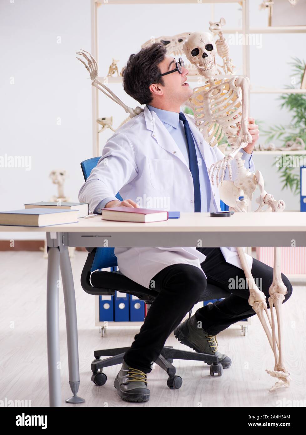 The crazy professor studying human skeleton Stock Photo - Alamy