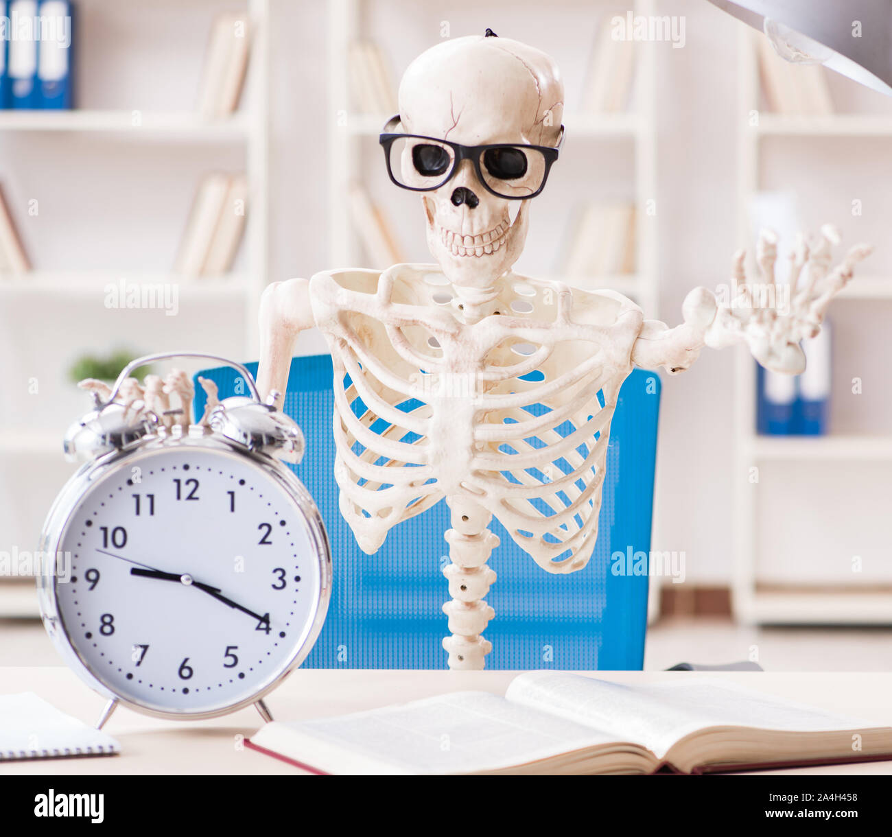 The skeleton businessman working in the office Stock Photo - Alamy