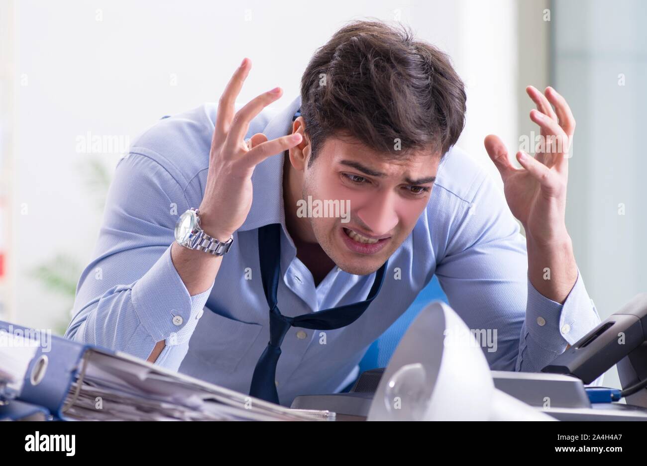 The angry businessman frustrated with too much work Stock Photo - Alamy