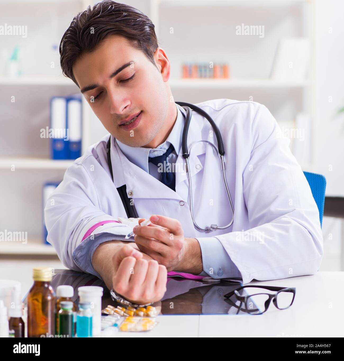 The doctor drug addict in the hospital Stock Photo - Alamy