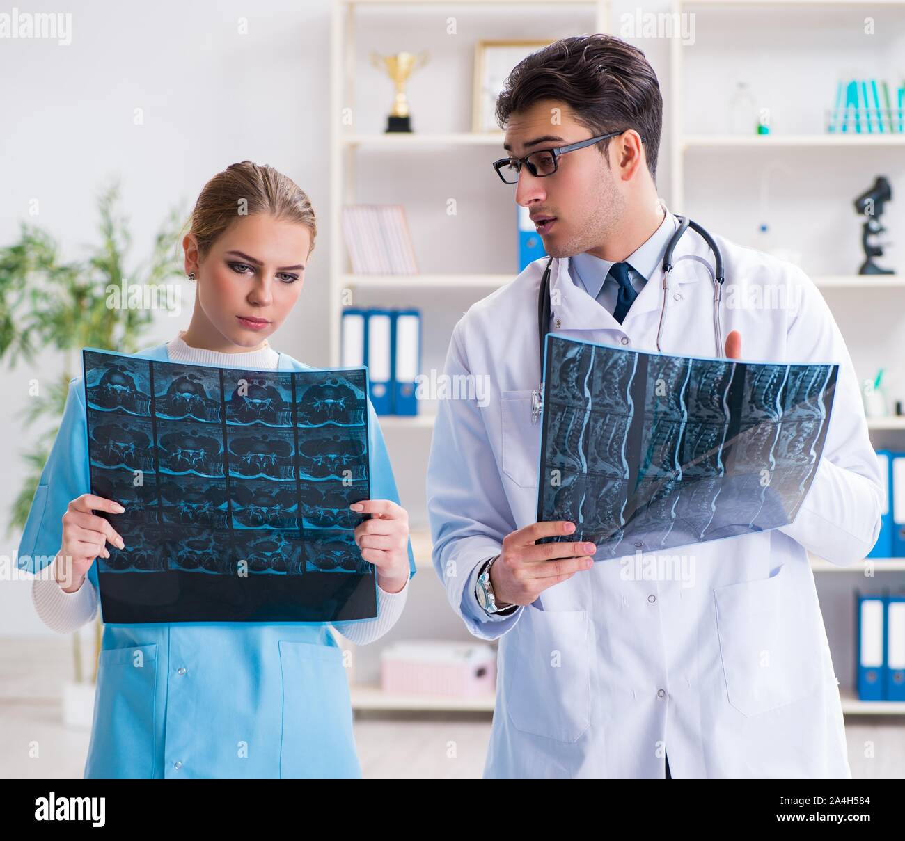 Two doctors examining x-ray images of patient for diagnosis Stock Photo ...
