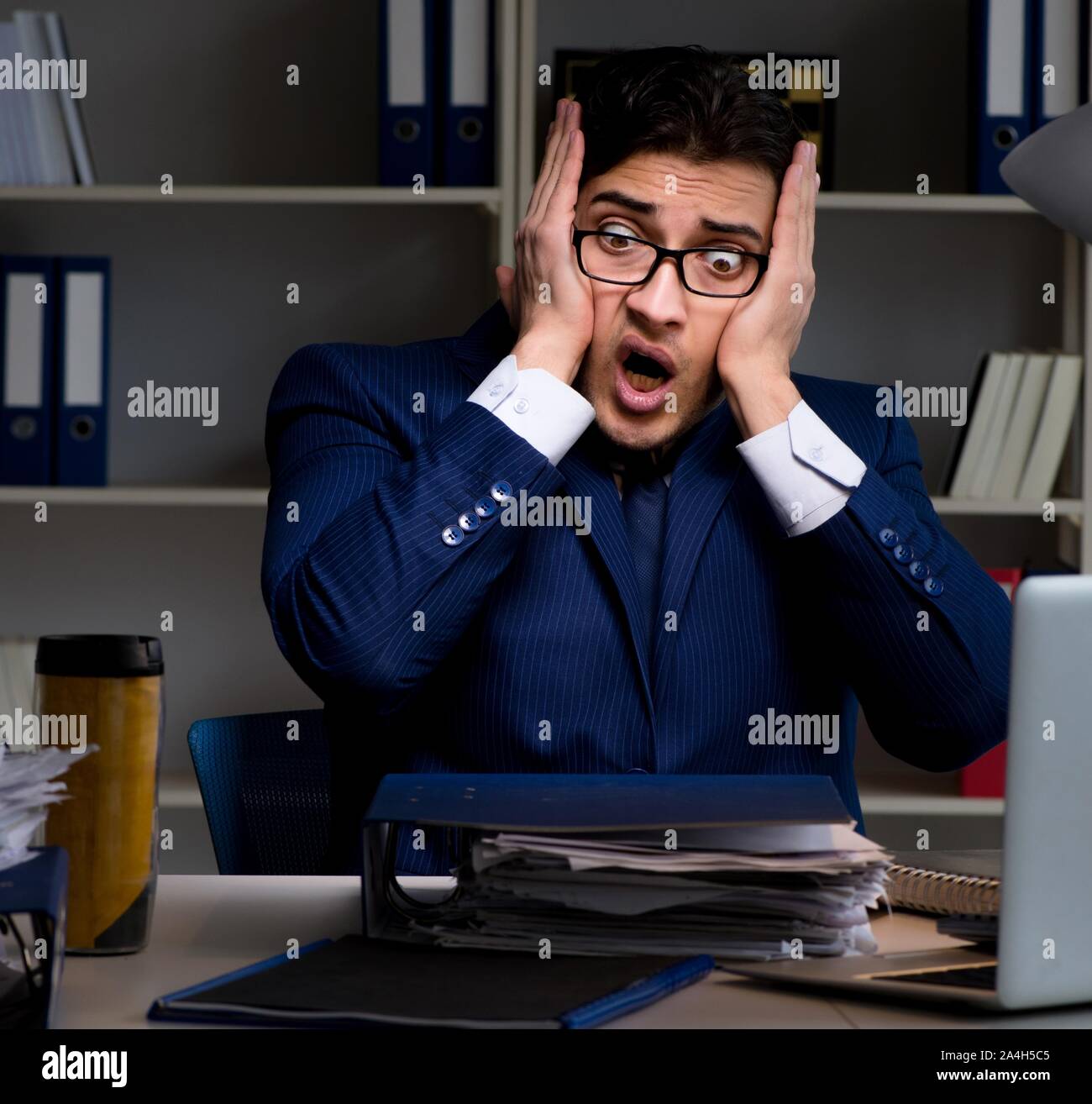 Employee working late to finish important deliverable task Stock Photo ...