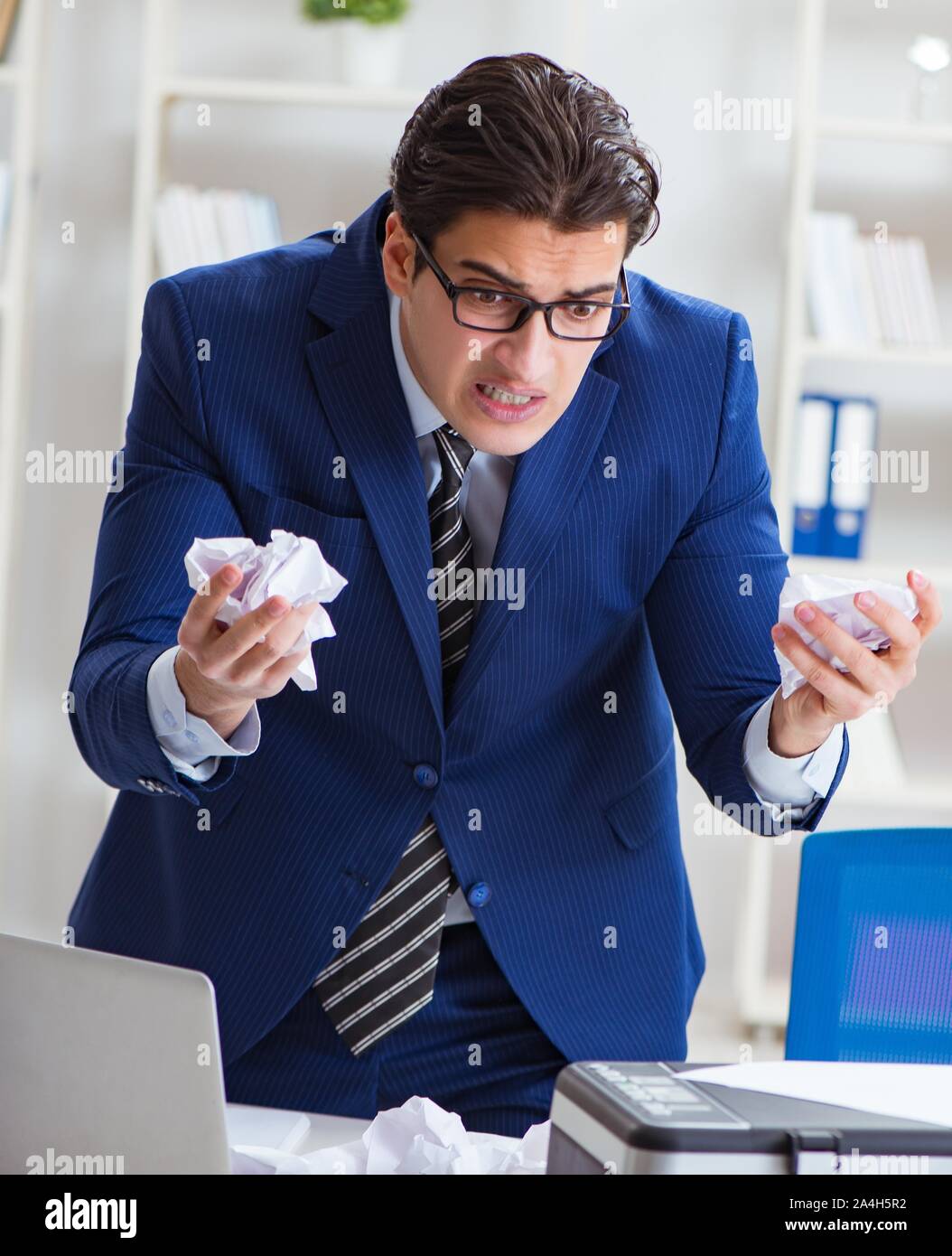 The businessman angry at copying machine jamming papers Stock Photo - Alamy
