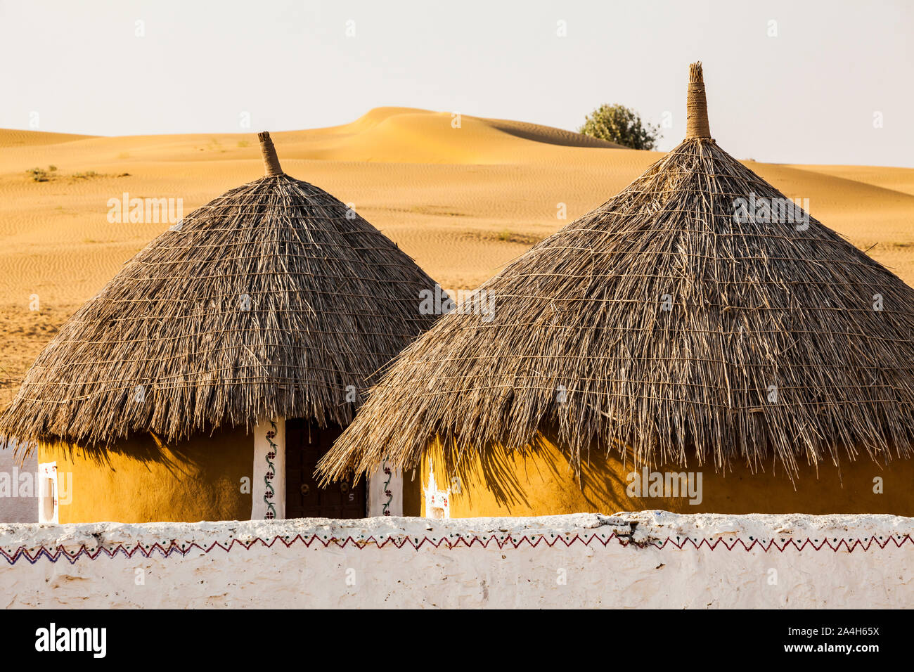 Thatched roof huts and sand dunes at Resort Rawla, Thar Desert ...