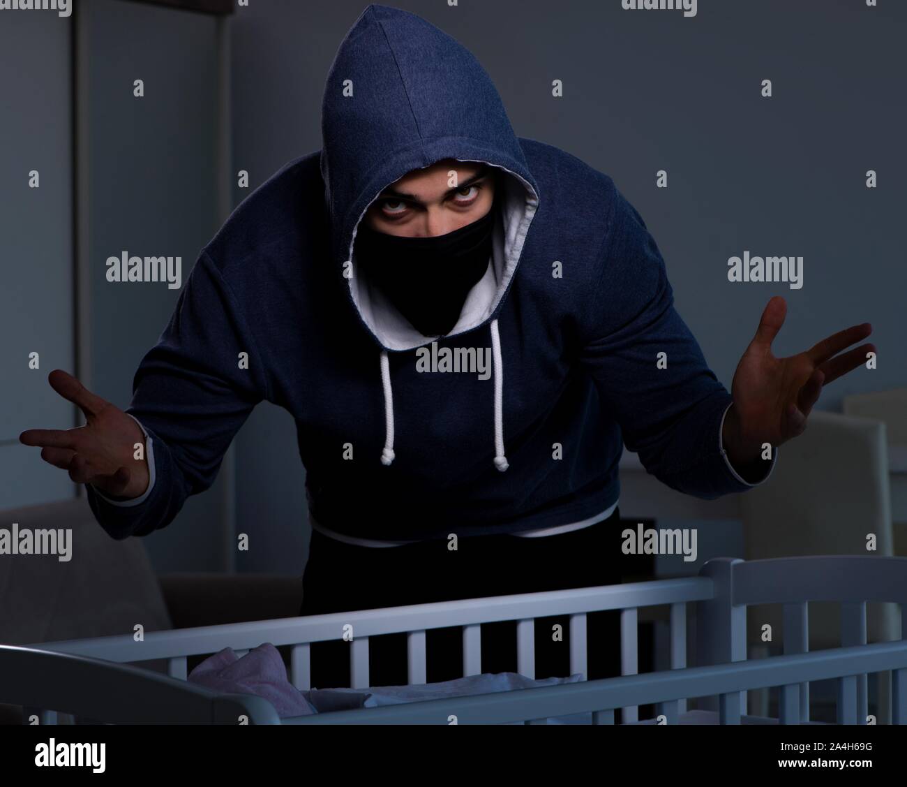 Criminal stealing baby in human child traficking concept Stock Photo ...