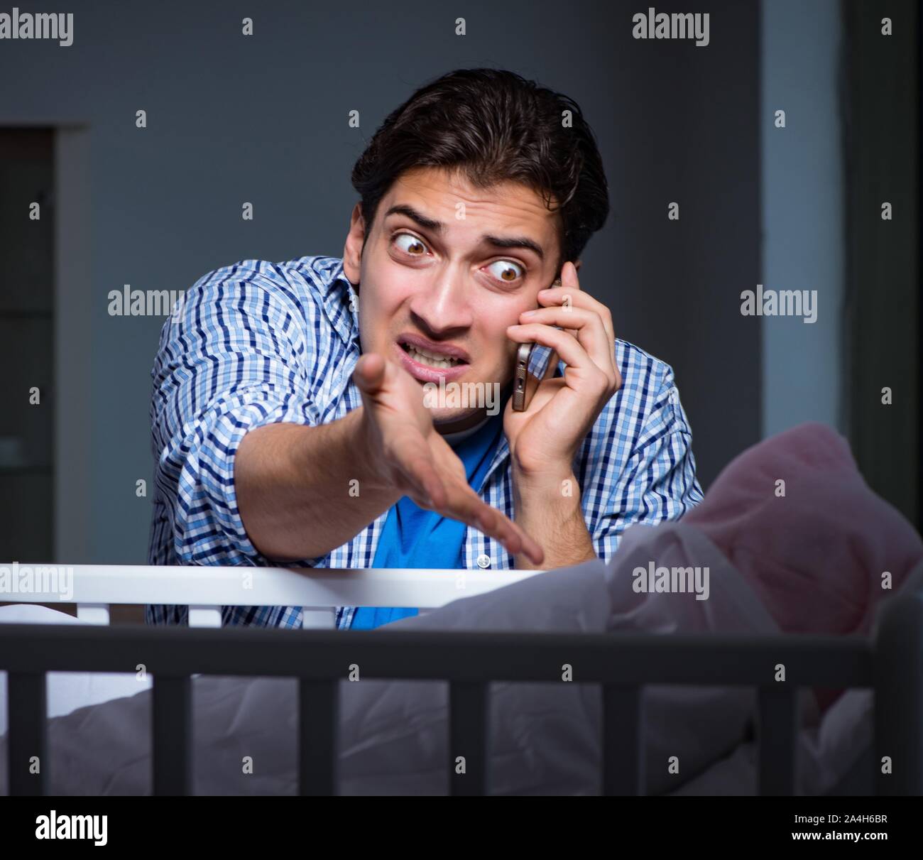 The young father under stress due to baby crying at night Stock Photo ...