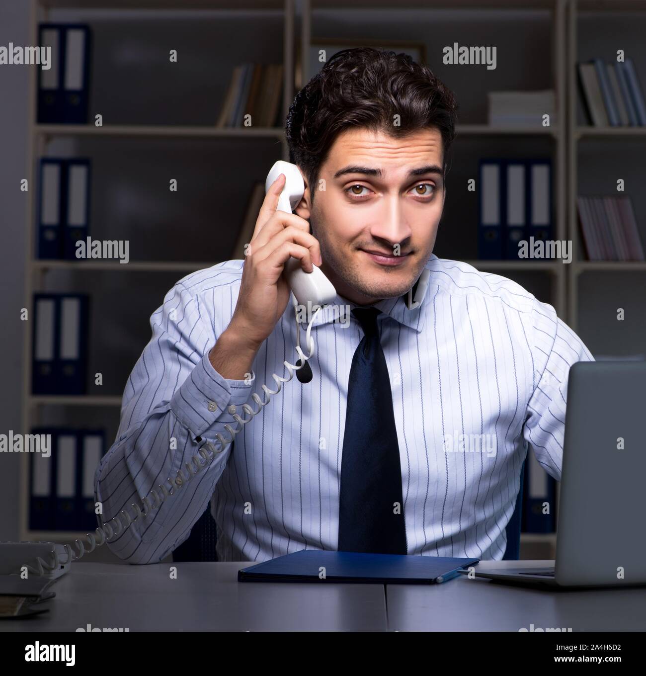 The call center operator talking to customer during night shift Stock ...