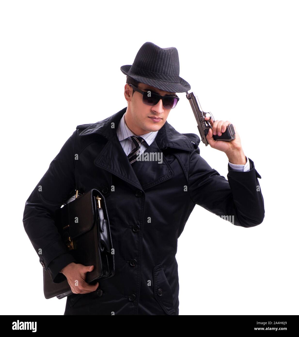 The man spy with handgun isolated on white background Stock Photo - Alamy